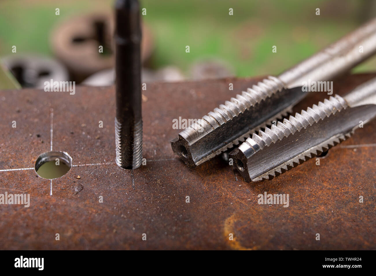 Manual thread cutting in metal. Locksmith accessories for small work in ...