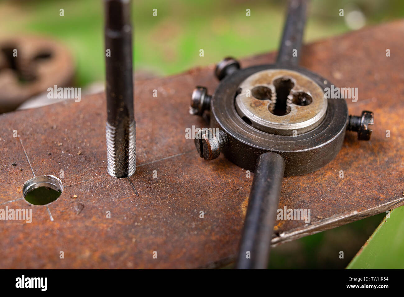 Manual thread cutting in metal. Locksmith accessories for small work in ...