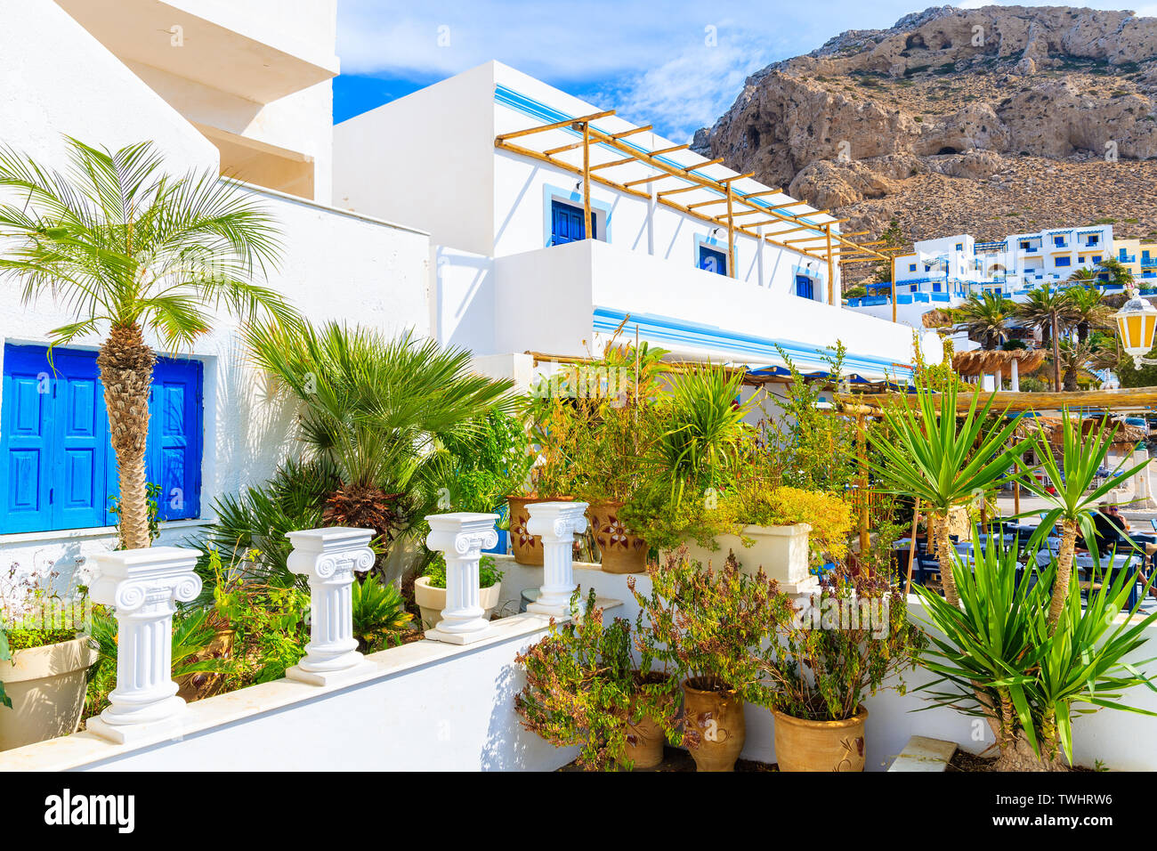 Tropical plants on terrace of traditional Greek taverna in Finiki port ...