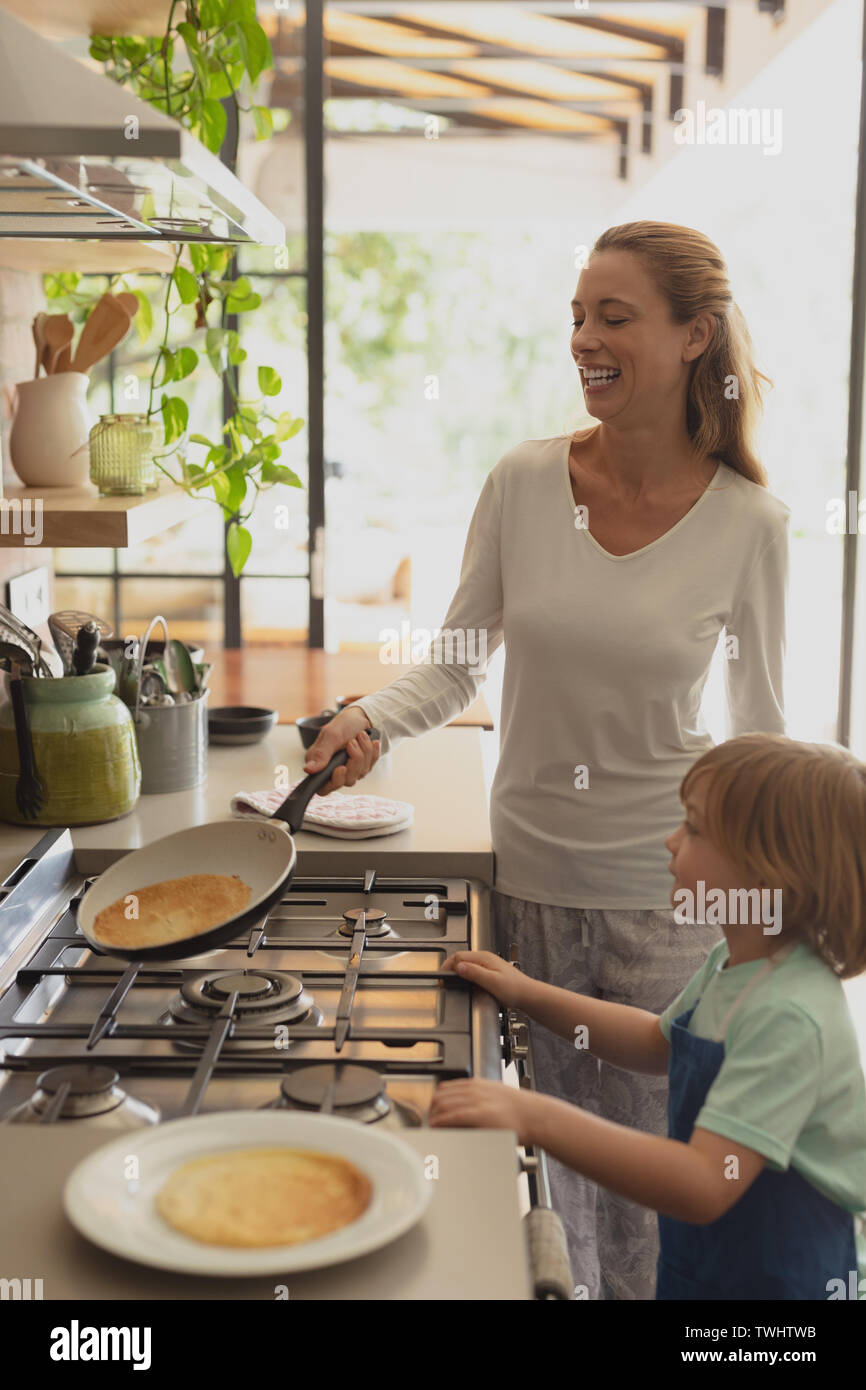 Mother and son preparing food in kitchen Stock Photo - Alamy