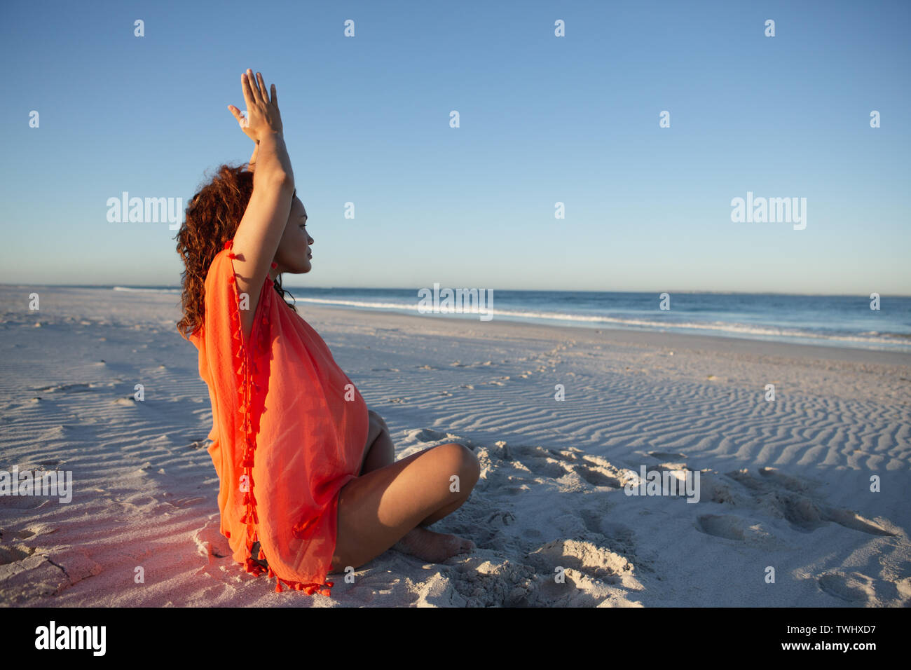 Beautiful woman doing yoga on beach in the sunshine Stock Photo - Alamy