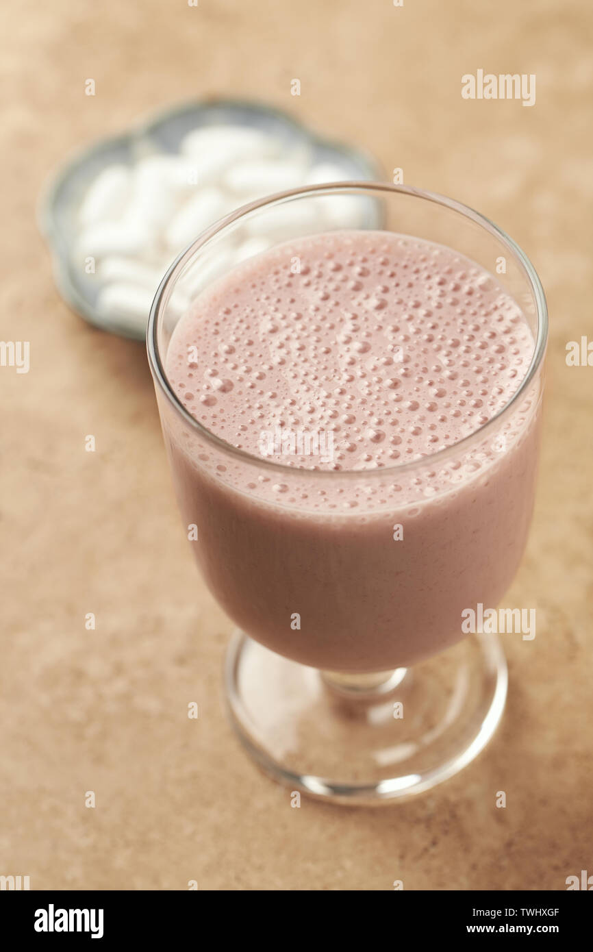 Glass of protein shake and BCAA amino acids. Nutrition for bodybuilding ...