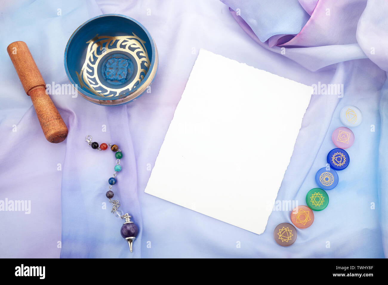 Natural crystals and pendulum on pastel silk background. Reiki ...