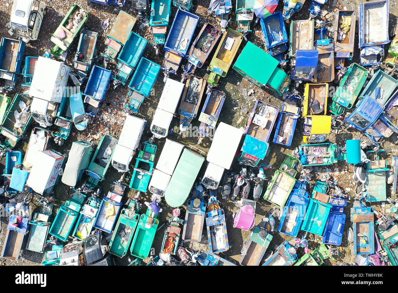 Piled together, scrap-out old motor vehicles waiting to be dismantled ...