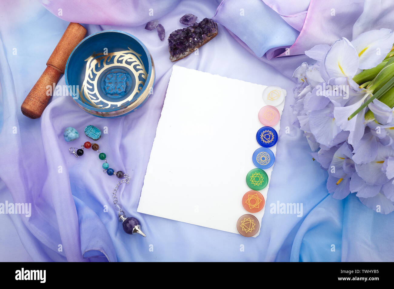 Natural crystals and pendulum on pastel silk background. Reiki ...