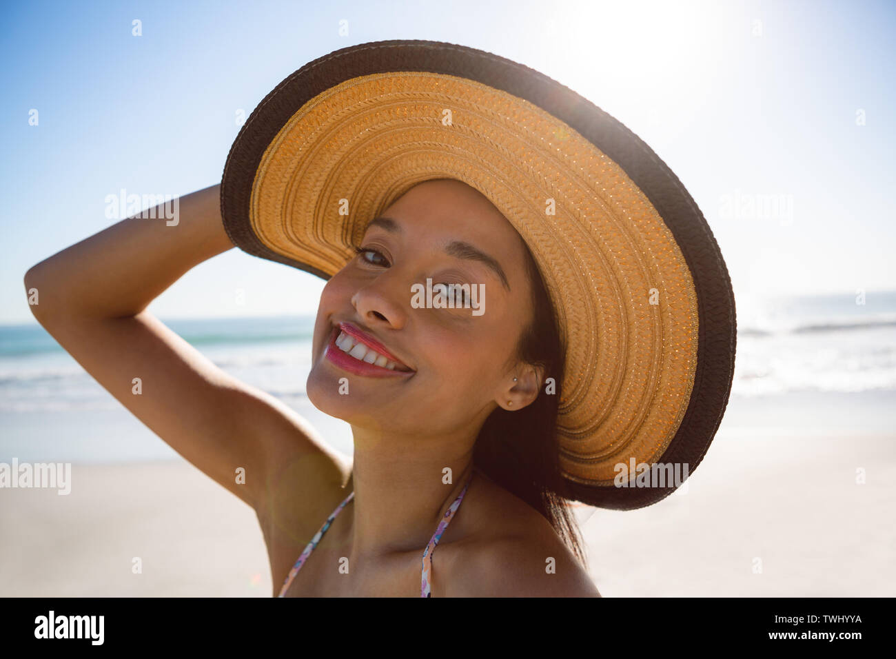 Beautiful woman in hat standing on the beach Stock Photo - Alamy