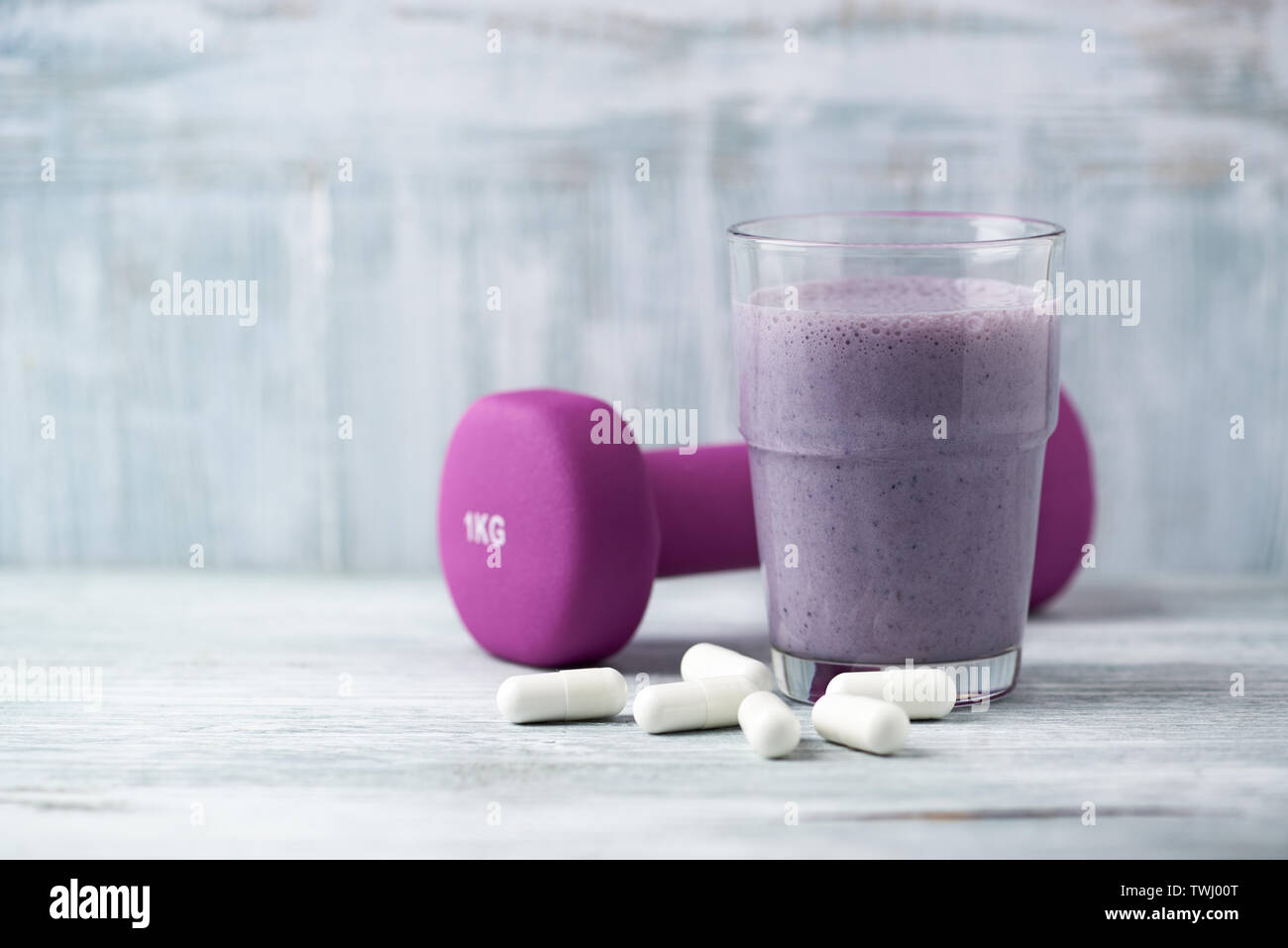 Glass of Protein Shake with milk and blueberries. BCAA amino acids and ...