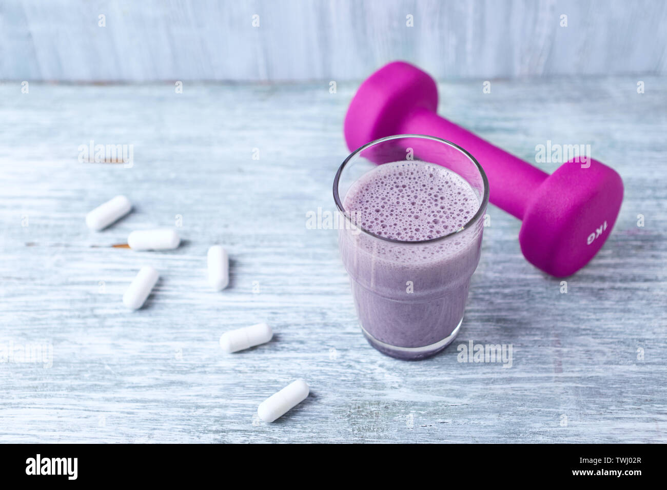 Glass of Protein Shake with milk and blueberries. BCAA amino acids and ...