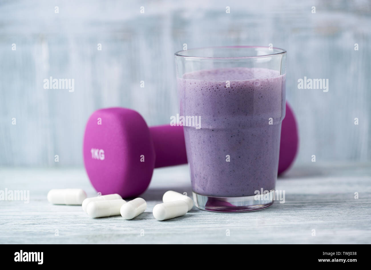 Glass of Protein Shake with milk and blueberries. BCAA amino acids and ...