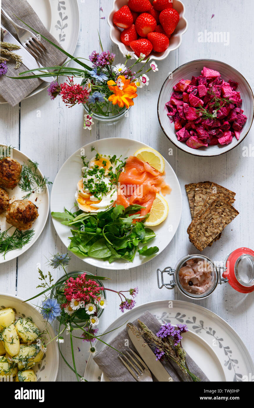 Scandinavian midsummer feast with potato salad, meatballs, salmon and ...