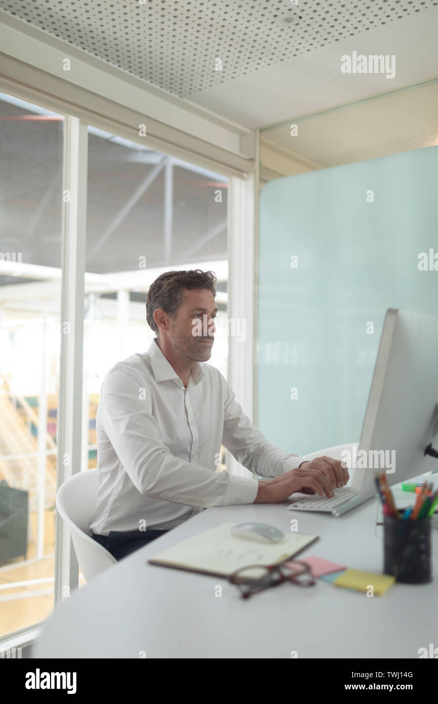 Business executive working on computer at desk in a modern office Stock ...
