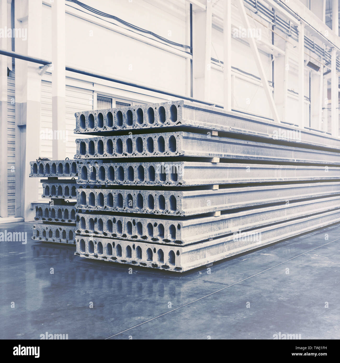 Stack of precast reinforced concrete slabs in a house-building factory ...