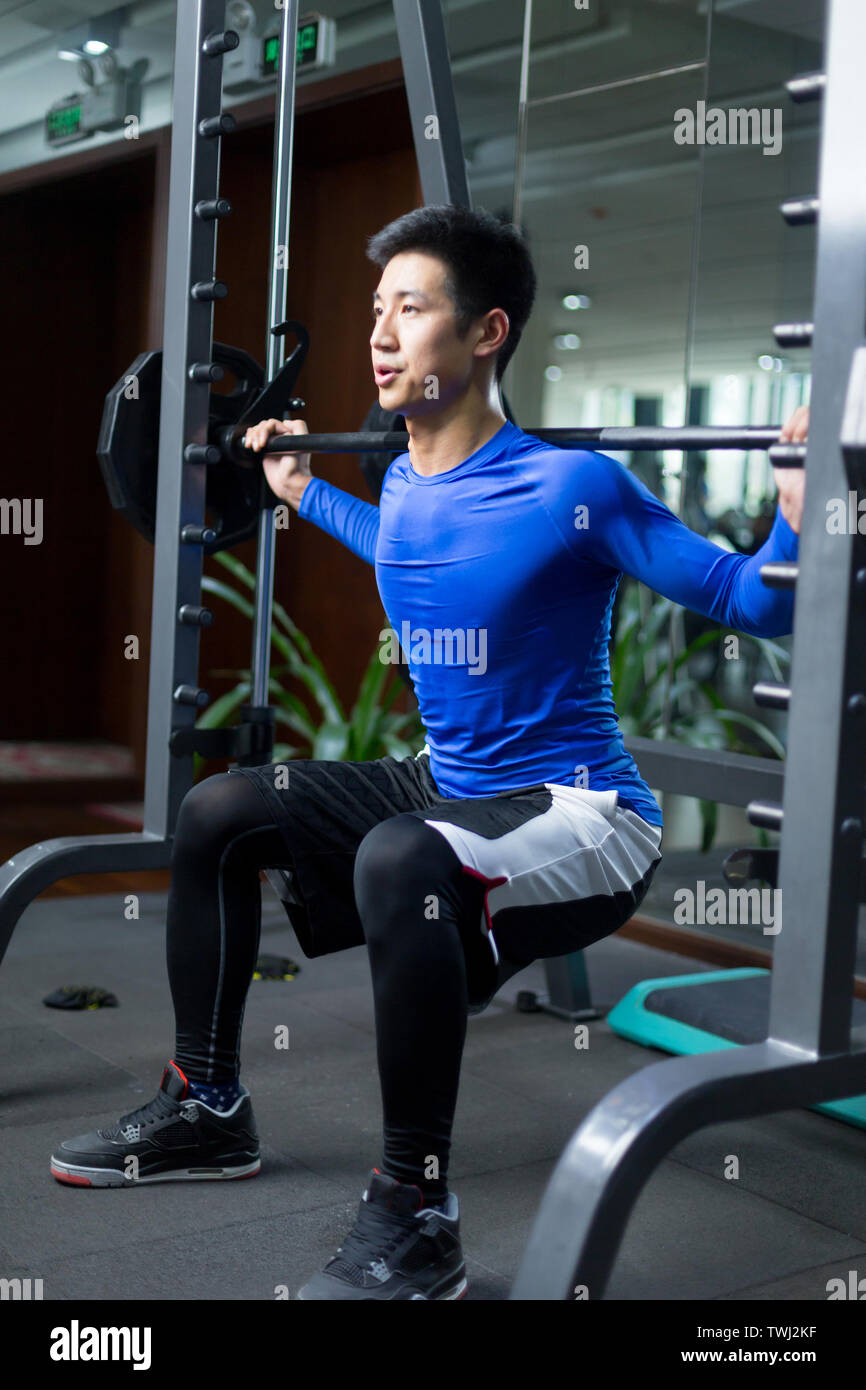 young asian man working out in modern gym Stock Photo - Alamy
