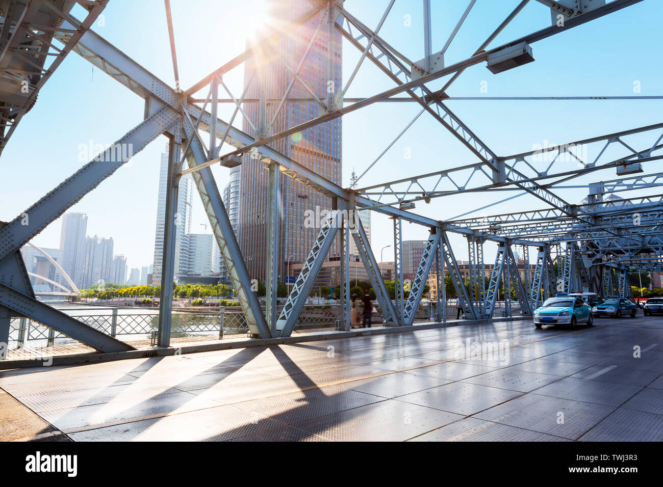 Traffic on steel bridge interior and skyline at sunset Stock Photo - Alamy