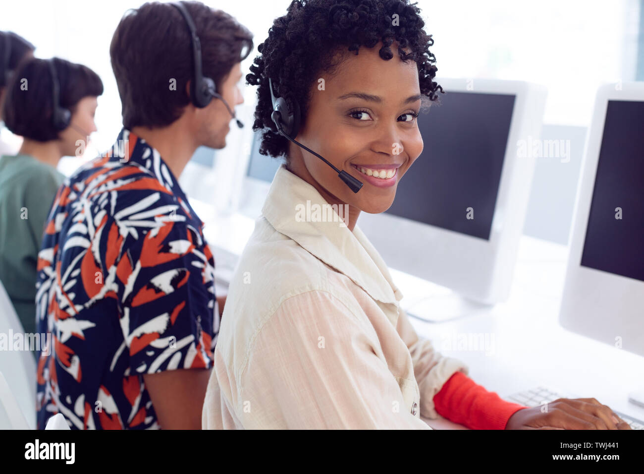 Female customer service executive working on computer at desk in office ...