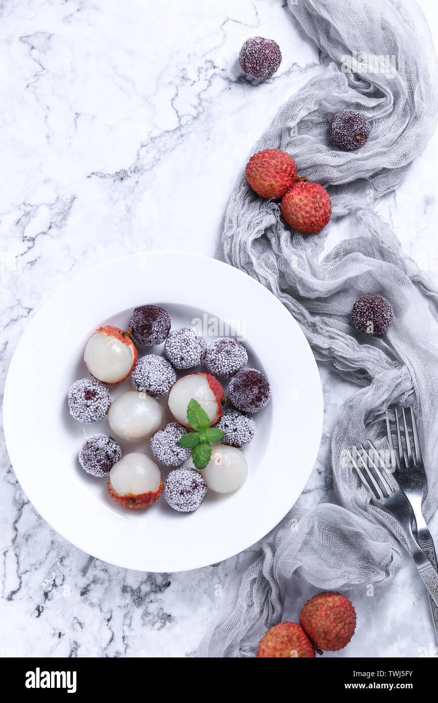 Frozen plum and fresh lychee Stock Photo - Alamy