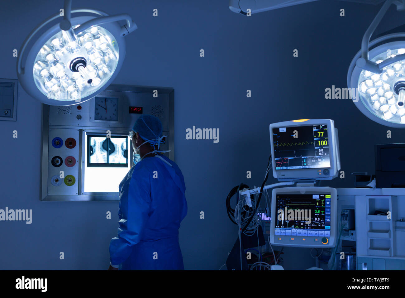 Male surgeon reading x ray in operating room at hospital Stock Photo ...