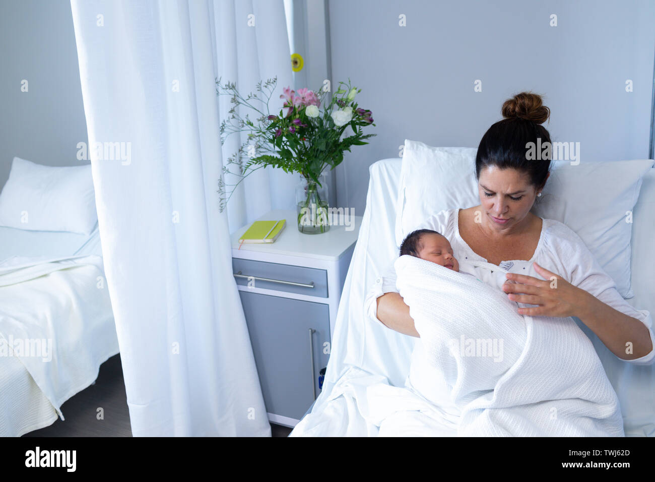 Mother holding newborn baby in hospital Stock Photo - Alamy