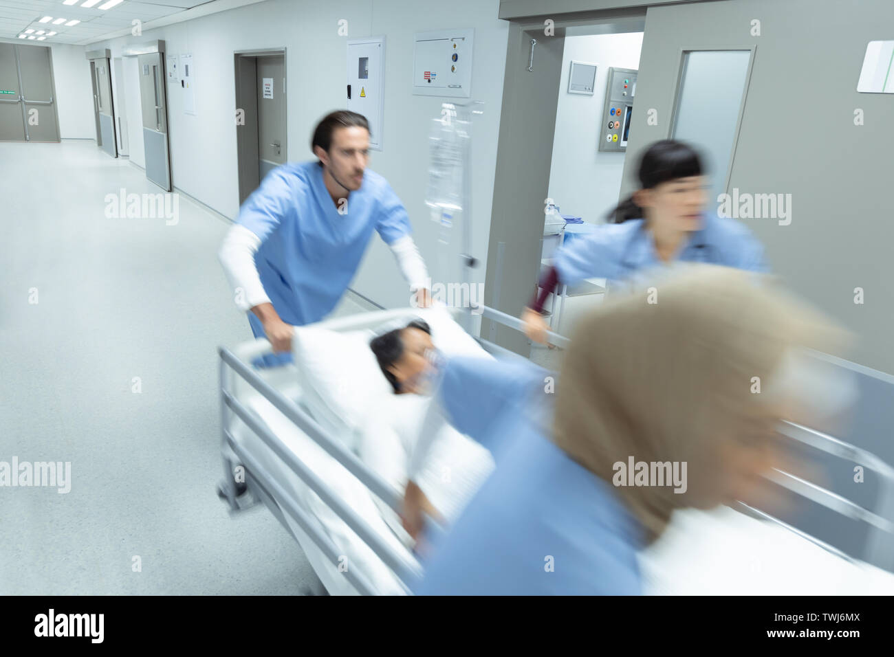 Medical team pushing emergency stretcher bed in corridor Stock Photo ...