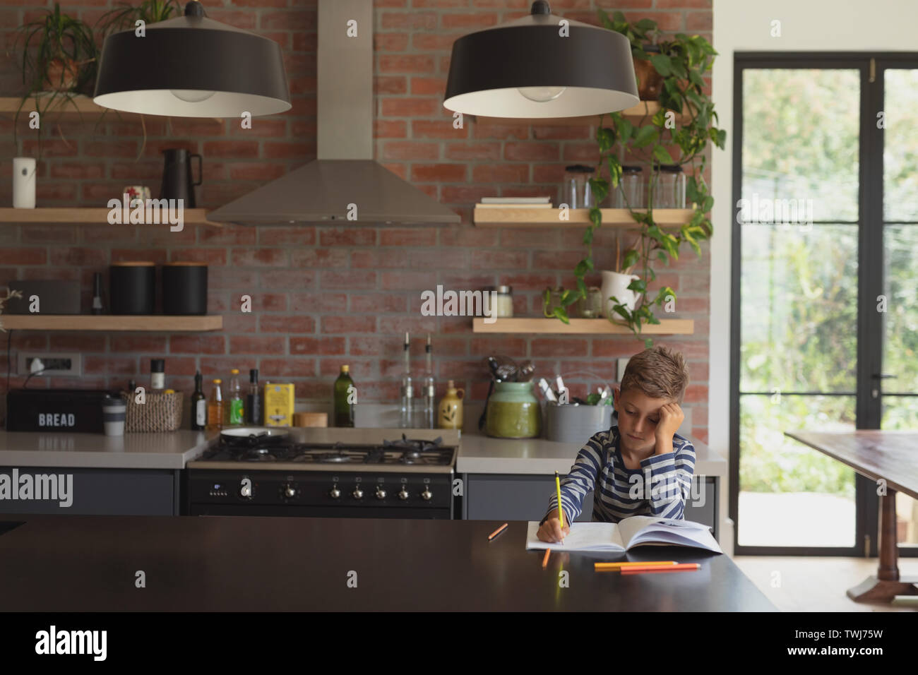 Boy studying table in kitchen hi-res stock photography and images - Alamy