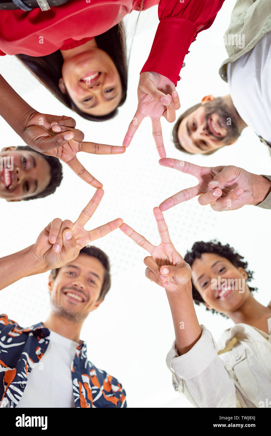 Business people forming star shape with their fingers in a modern ...