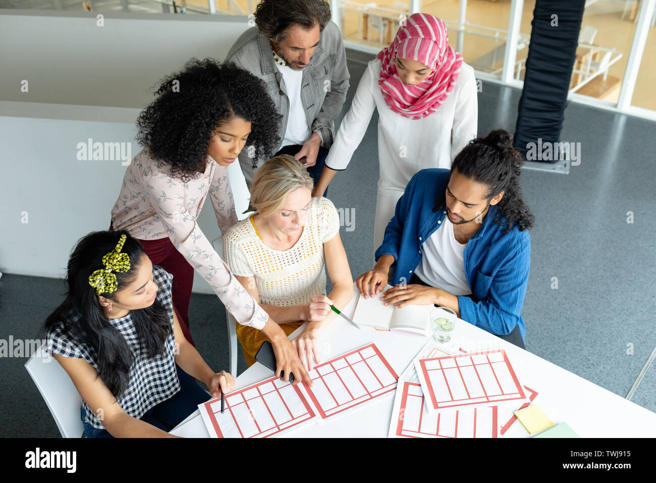 Business people discussing together over documents at conference room ...