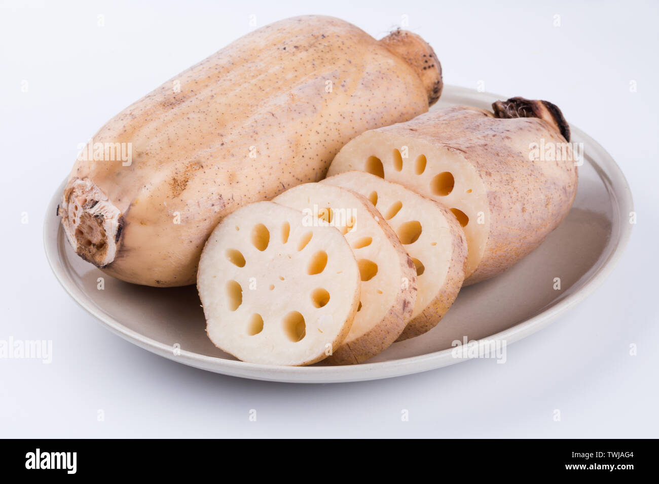Fresh lotus root on white background Stock Photo - Alamy