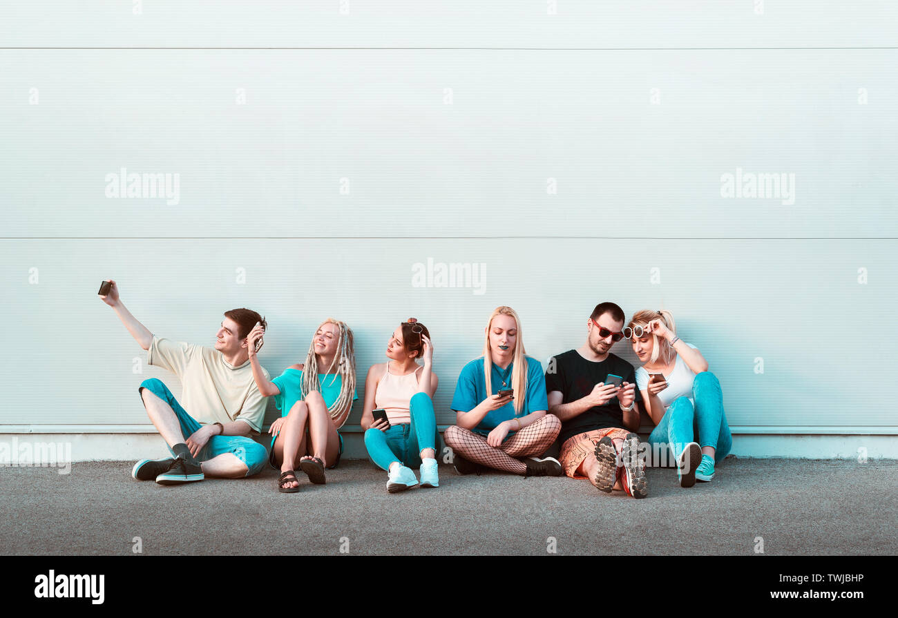 Group of young people using their mobile phones Stock Photo - Alamy