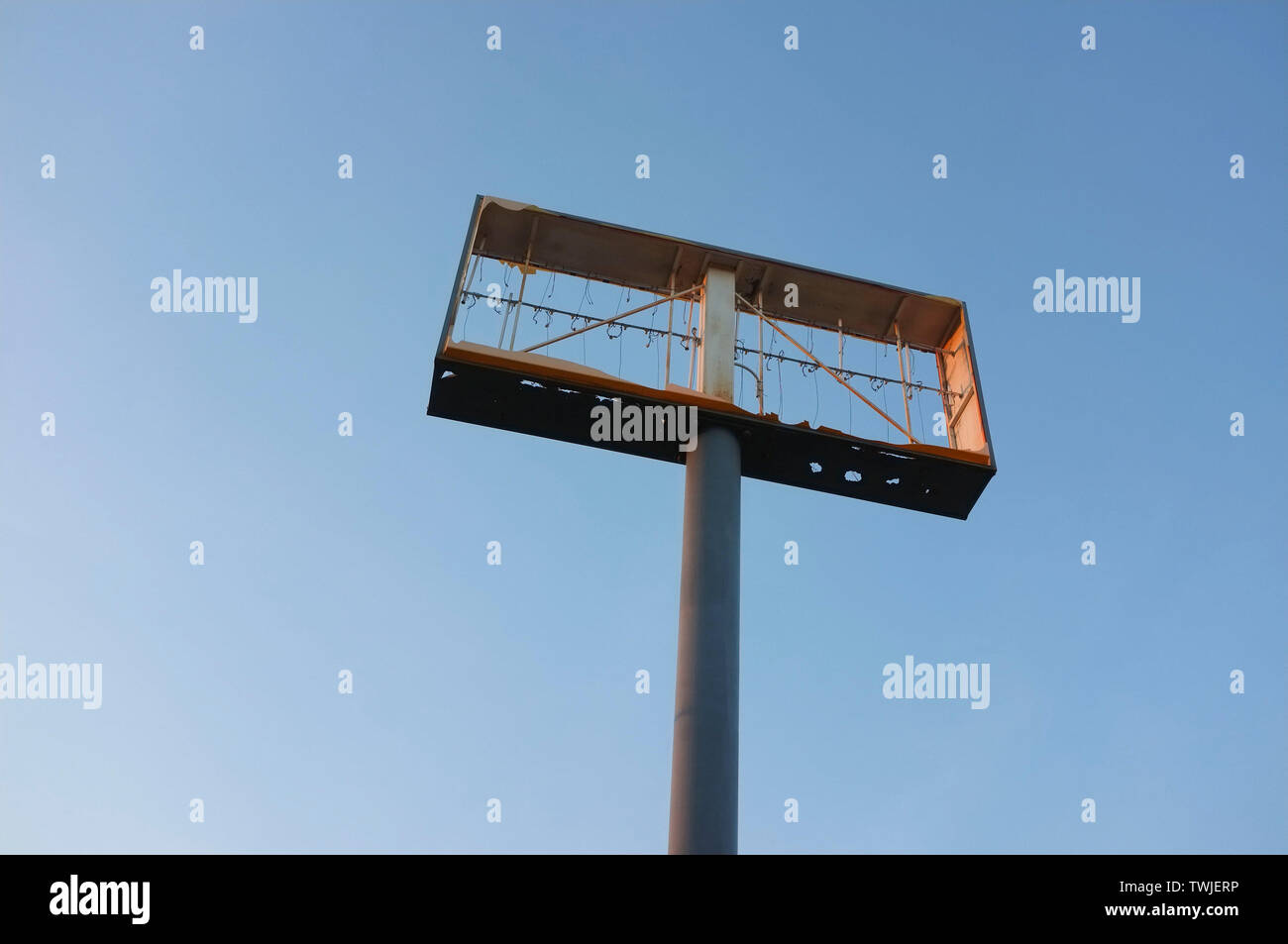 A derelict and destroyed advertising sign against a blue sky Stock ...
