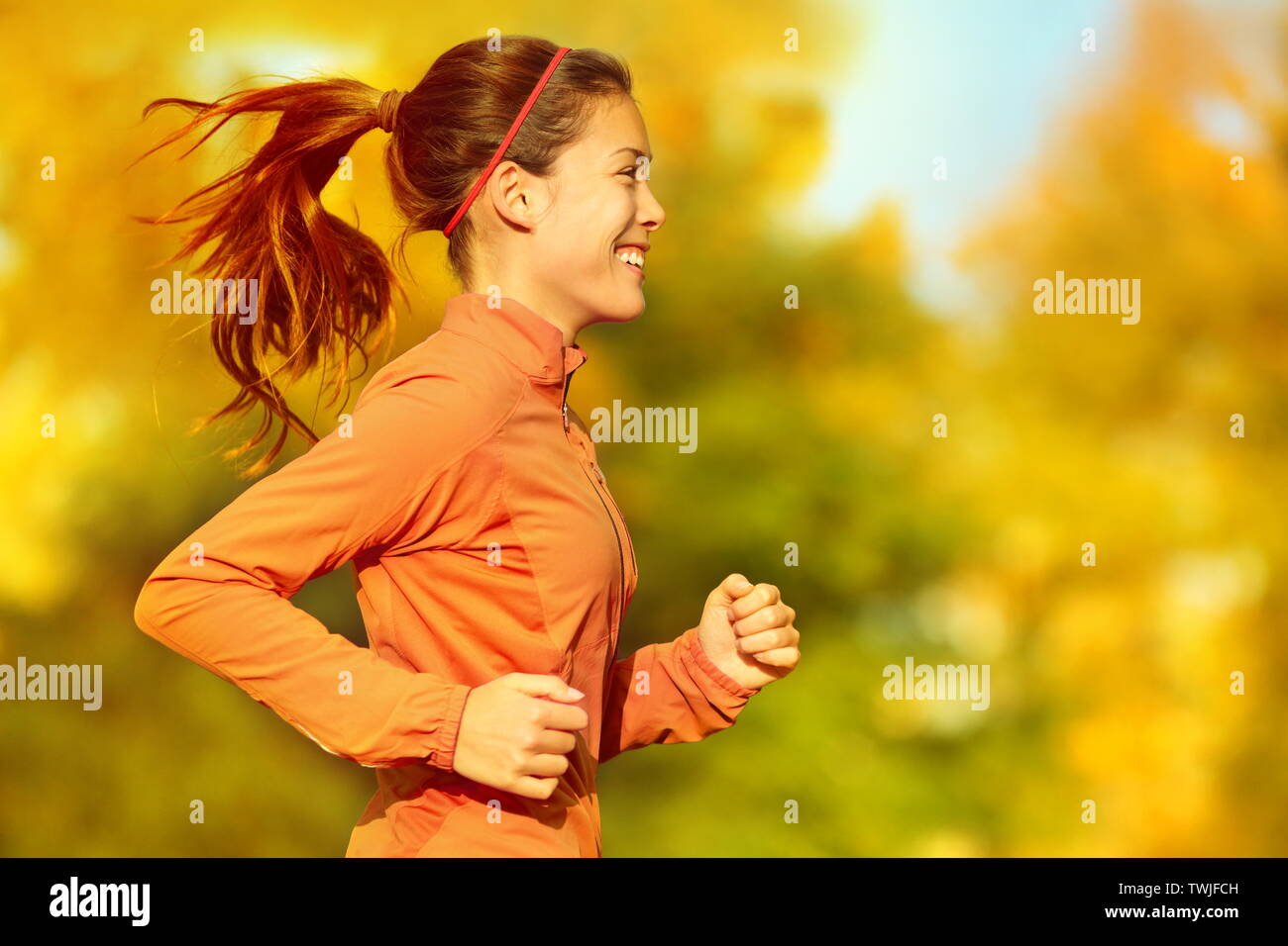 Woman runner running in fall autumn forest. Female fitness girl jogging ...