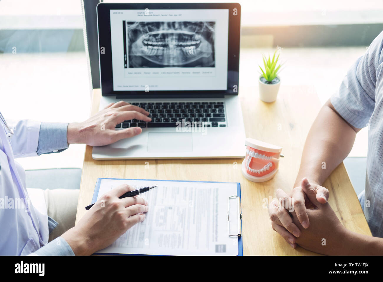 Dental hygienist demonstrating and showing a dummy jaw to chack-up or ...