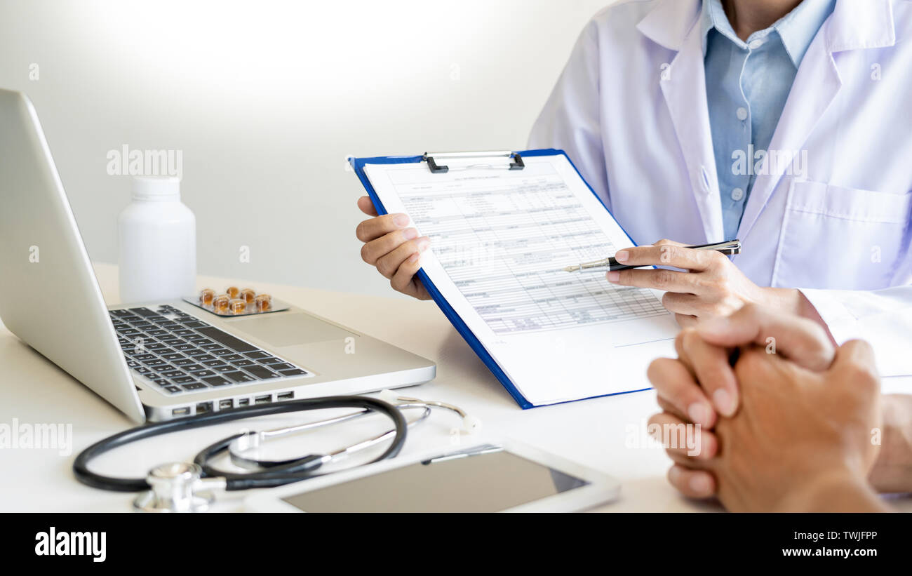 Doctor explaining for patient and showing medical records informations ...