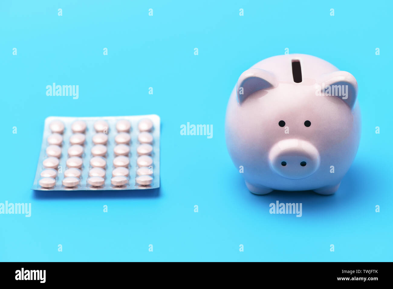 Pink piggy Bank in the form of a pig is on the right blue background ...