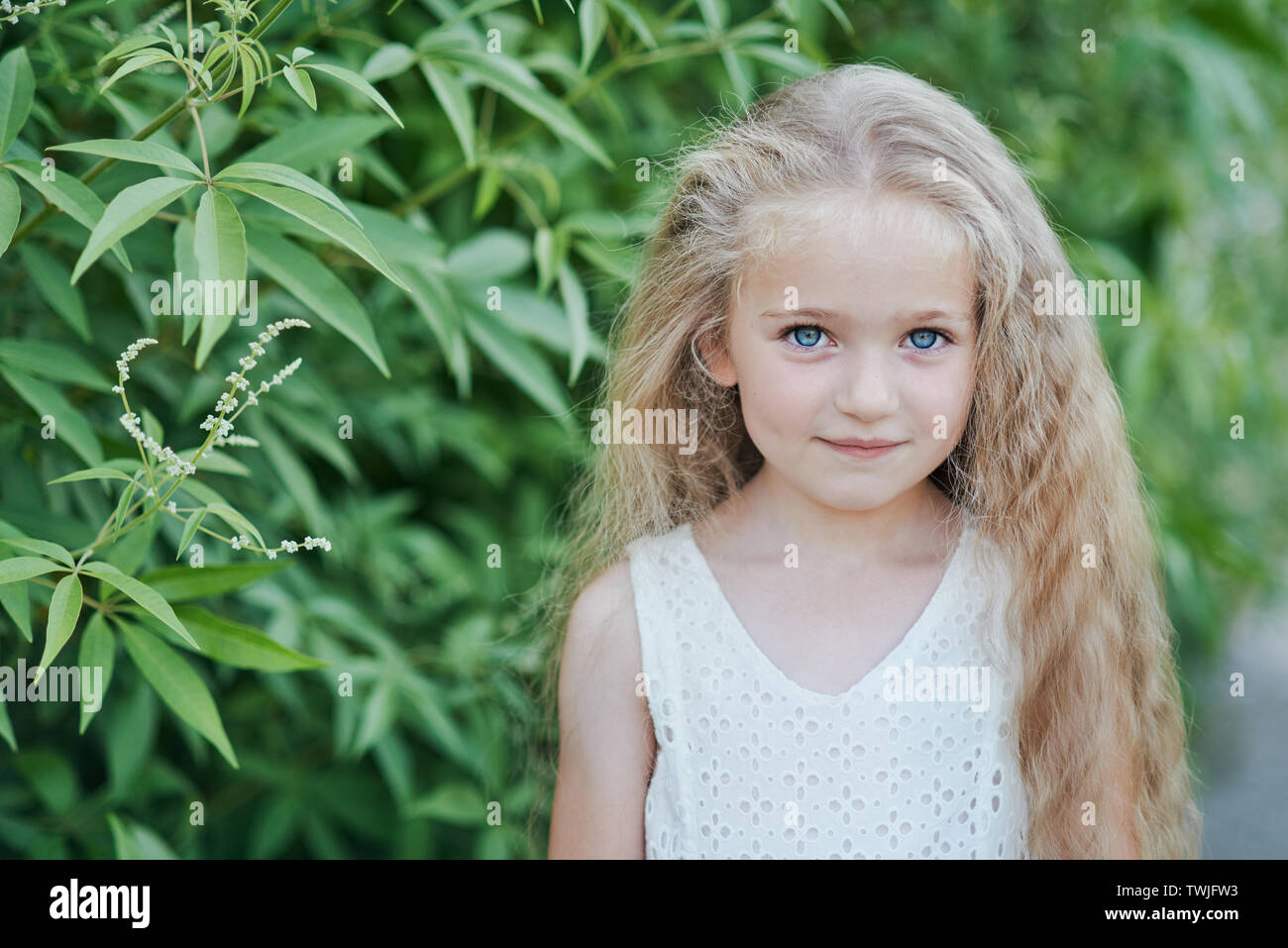 Close up portrait of beautiful little girl with blonde long hair and ...