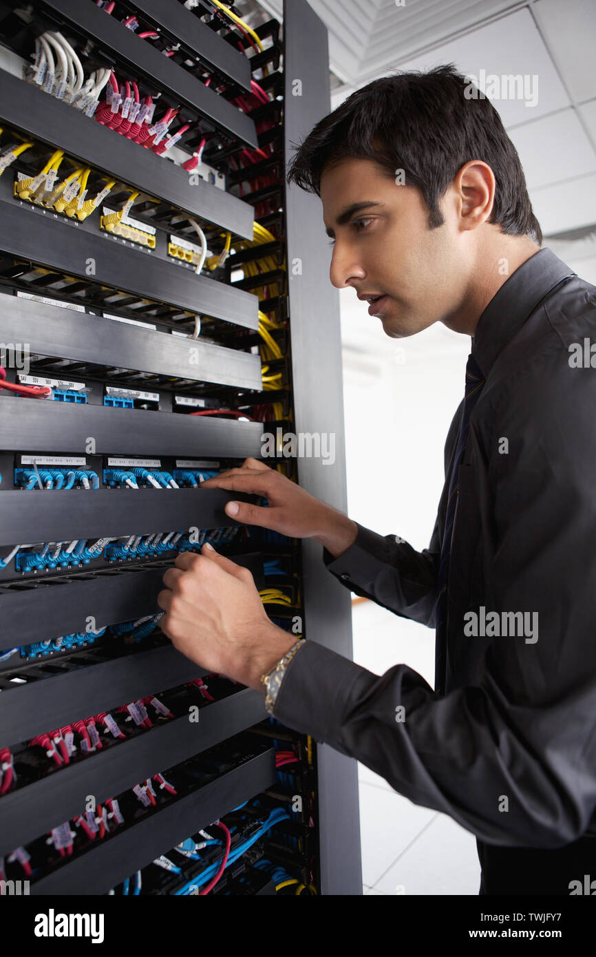 Technician working in a server room Stock Photo - Alamy