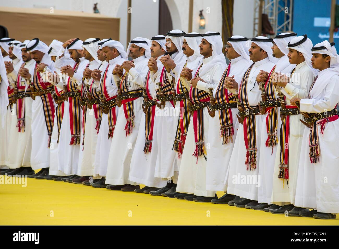 Traditional dressed local men dancing at the Al Janadriyah Festival ...