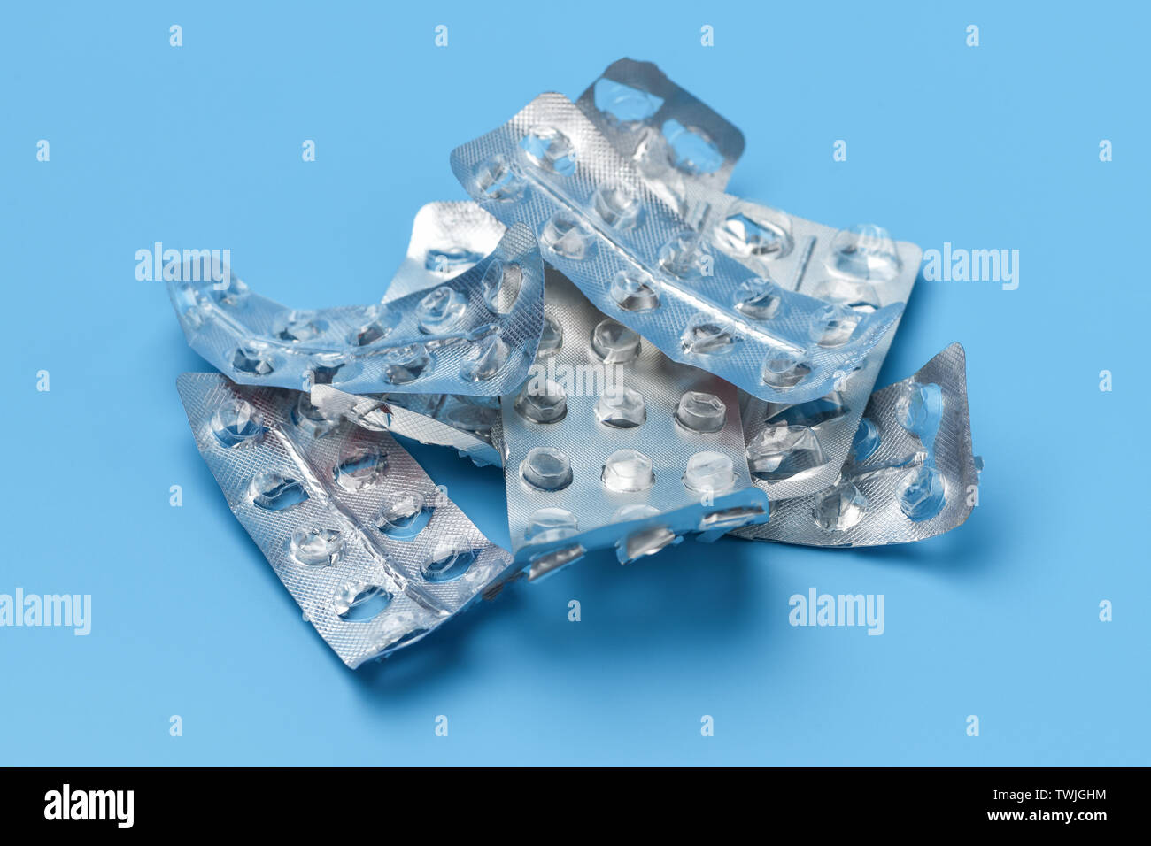 Lots of empty pill packs on a blue background. Medical background Stock ...