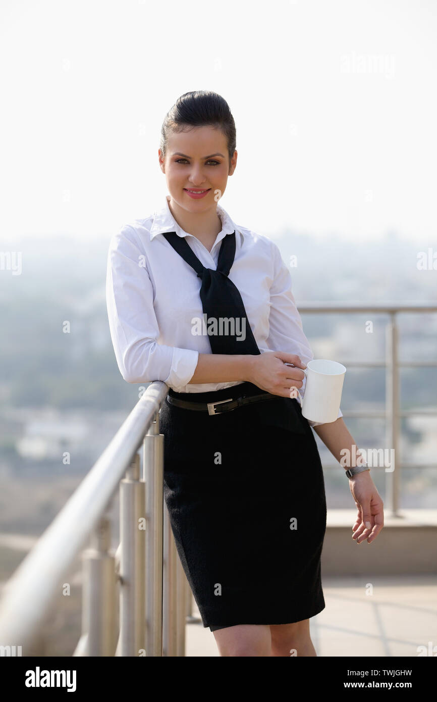 Businesswoman leaning against railing hi-res stock photography and ...