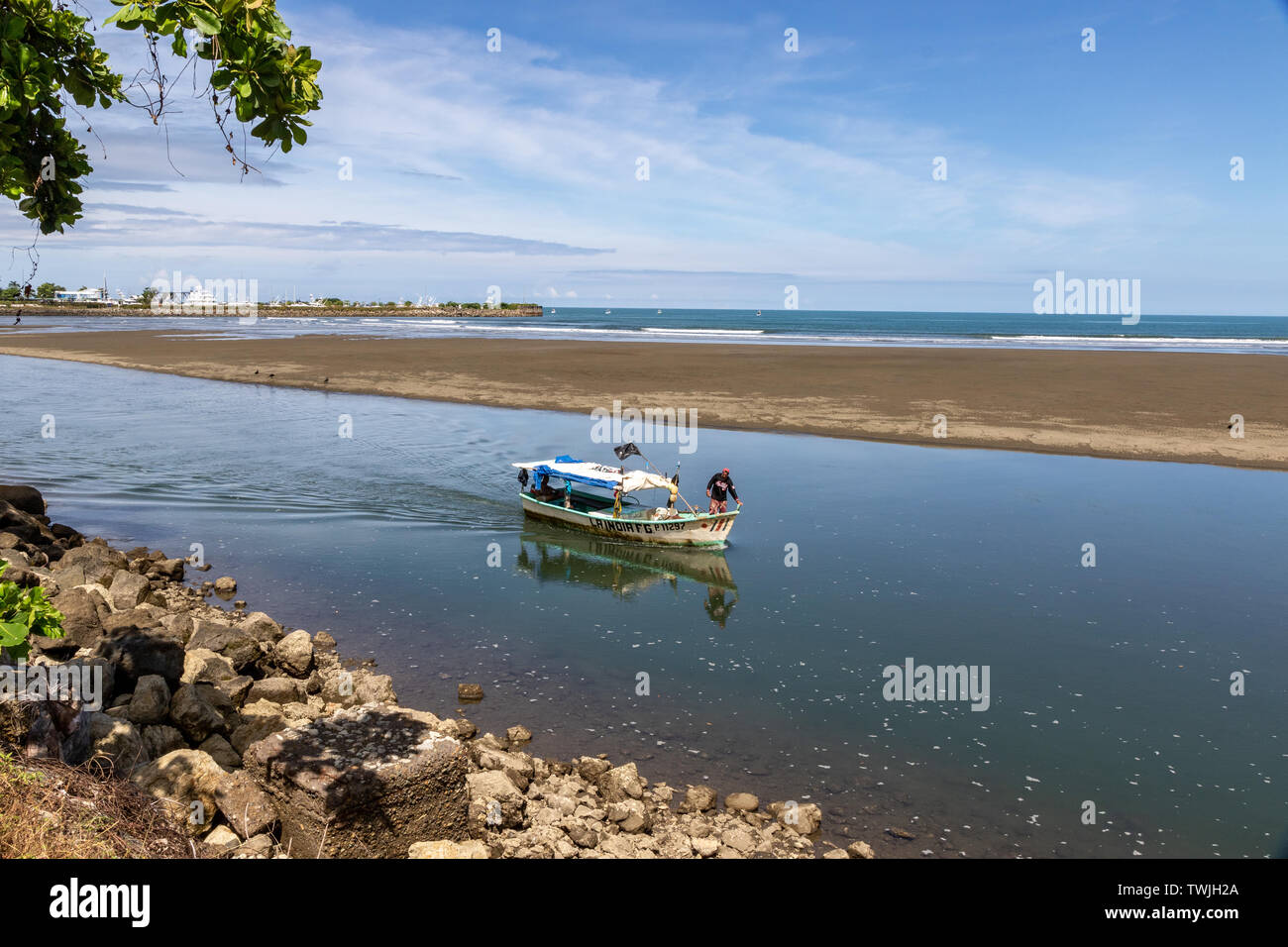 Locals fishing in their boats and onshore in Quepos, Costa Rica. Quepos ...