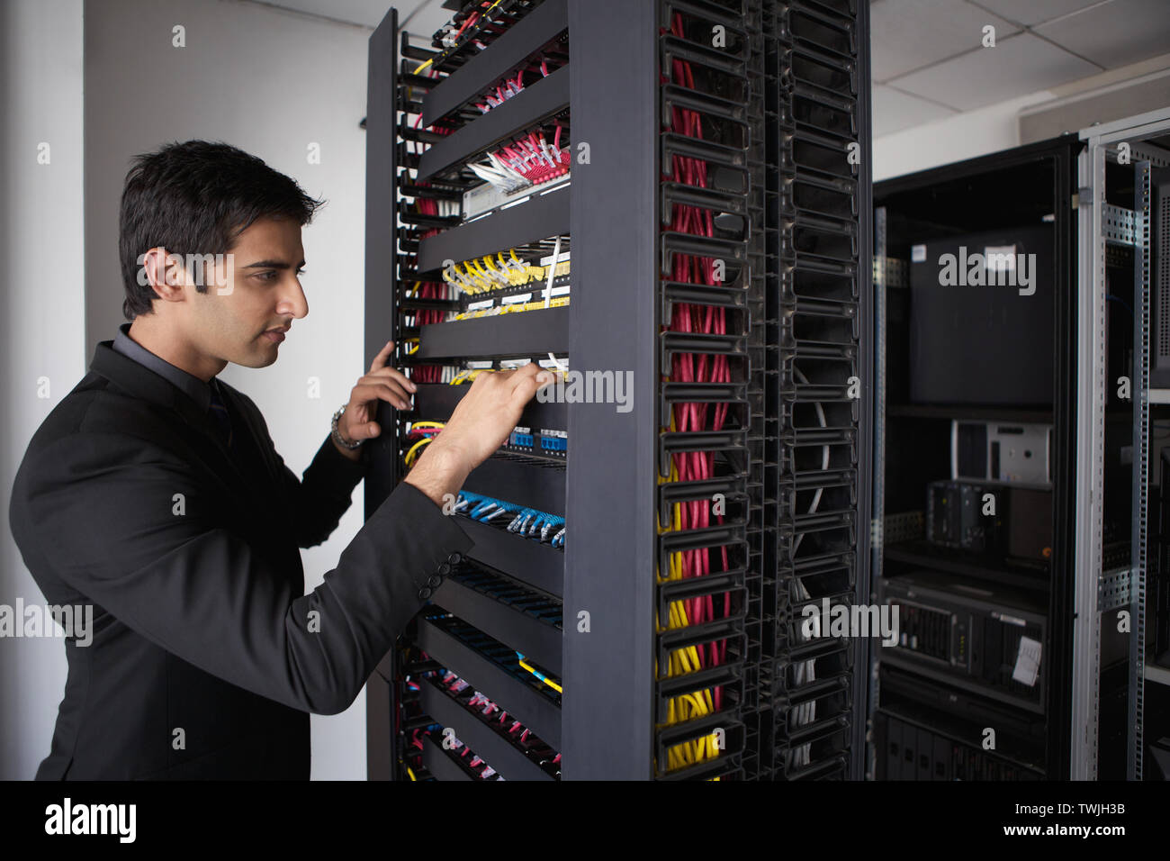 Technician working in a server room Stock Photo - Alamy