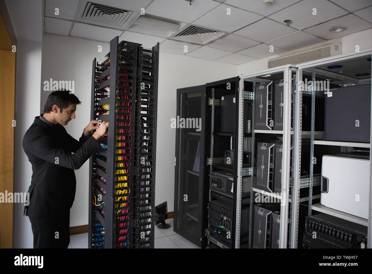 Technician working in a server room Stock Photo - Alamy