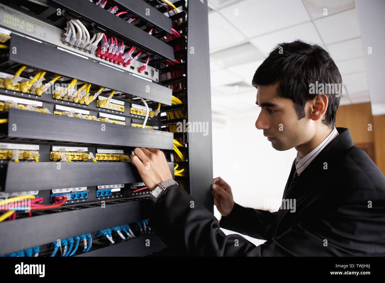 Technician working in a server room Stock Photo - Alamy