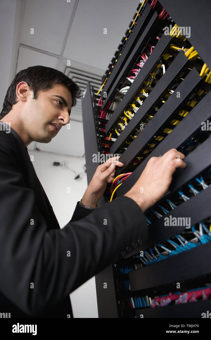 Technician working in a server room Stock Photo - Alamy