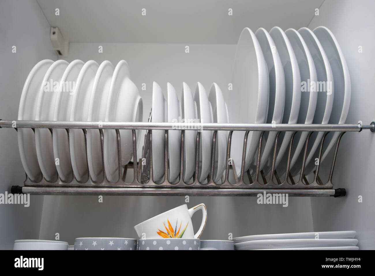 Row of mugs in kitchen cupboard hi-res stock photography and images - Alamy