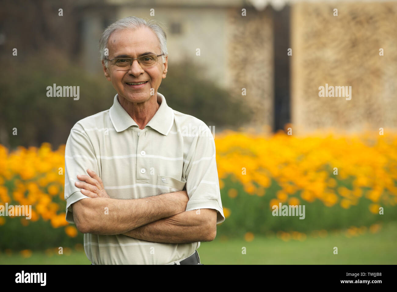 Portrait of an old man smiling with arms crossed Stock Photo - Alamy