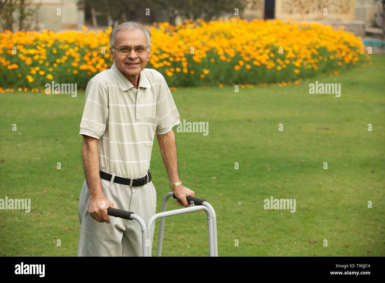 Old man walking with a walker Stock Photo - Alamy