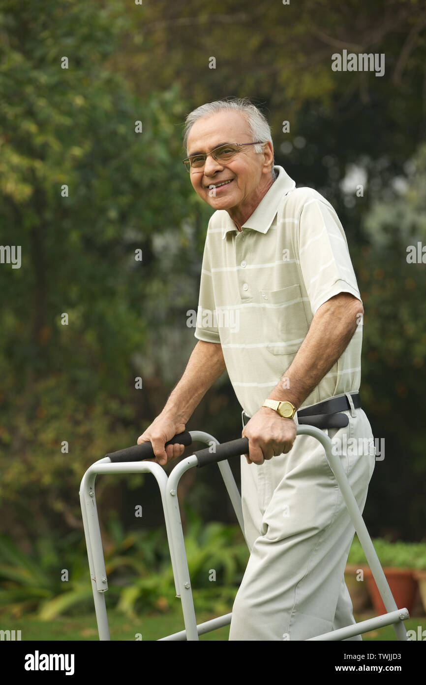 Indian old man walking walker hi-res stock photography and images - Alamy
