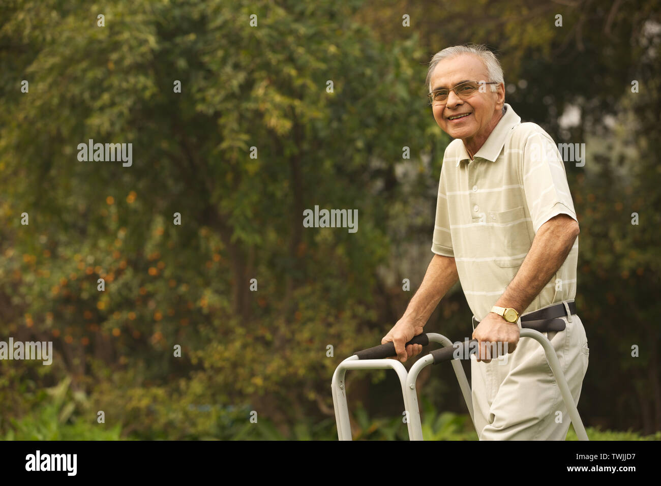 Old man walking with a walker Stock Photo - Alamy
