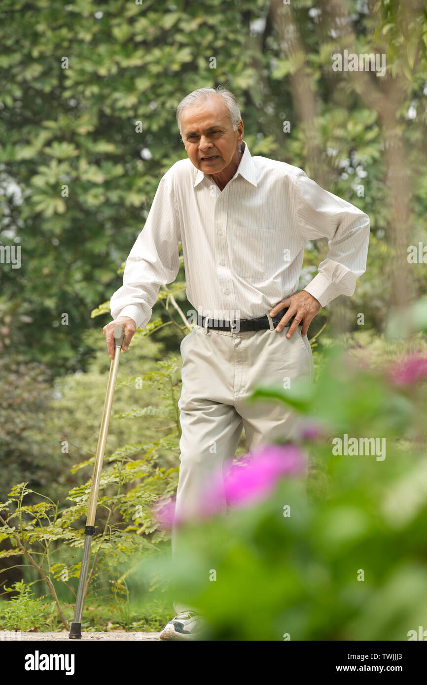 Old man walking with a cane Stock Photo - Alamy