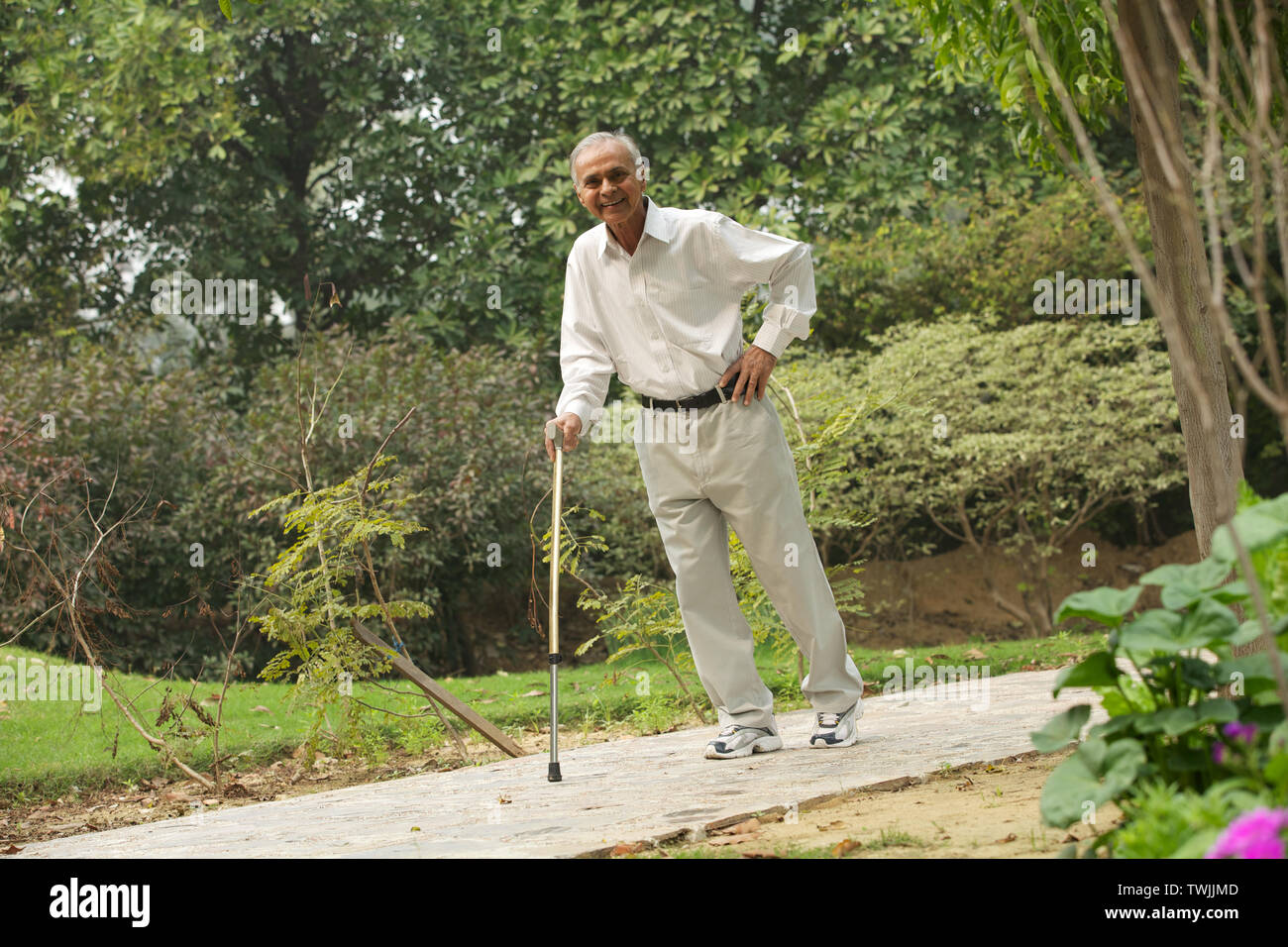 Old man walking with a cane Stock Photo - Alamy